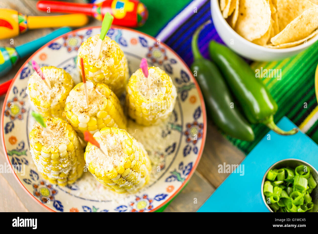 Fiesta party buffet table with spicy mexican corn on the cob and other ...