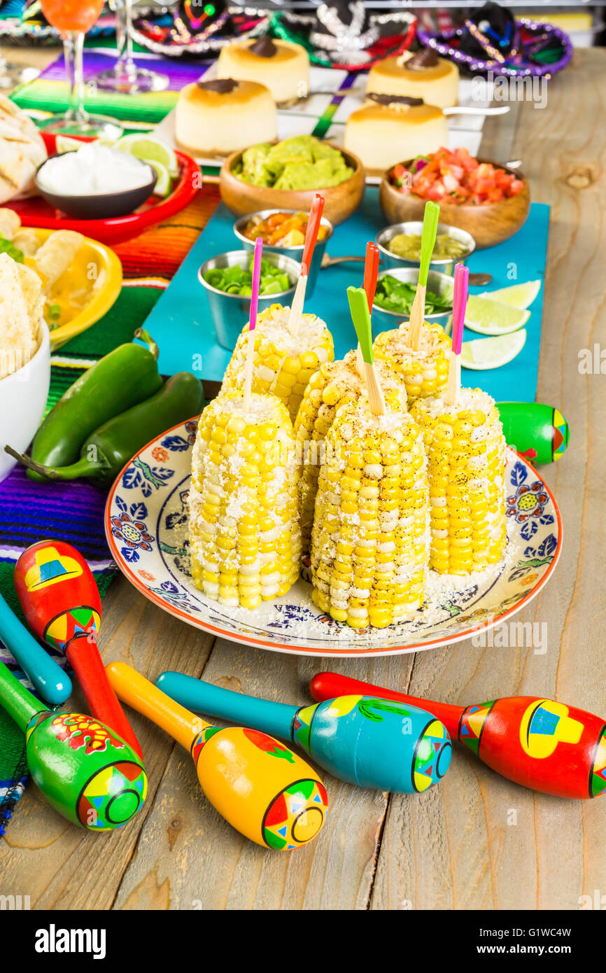 Fiesta party buffet table with spicy mexican corn on the cob and other ...