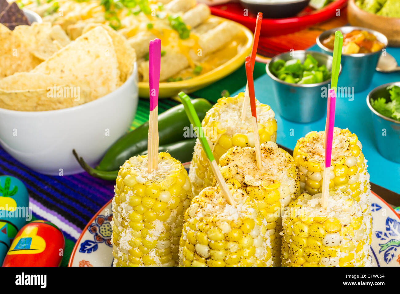 Fiesta party buffet table with spicy mexican corn on the cob and other ...