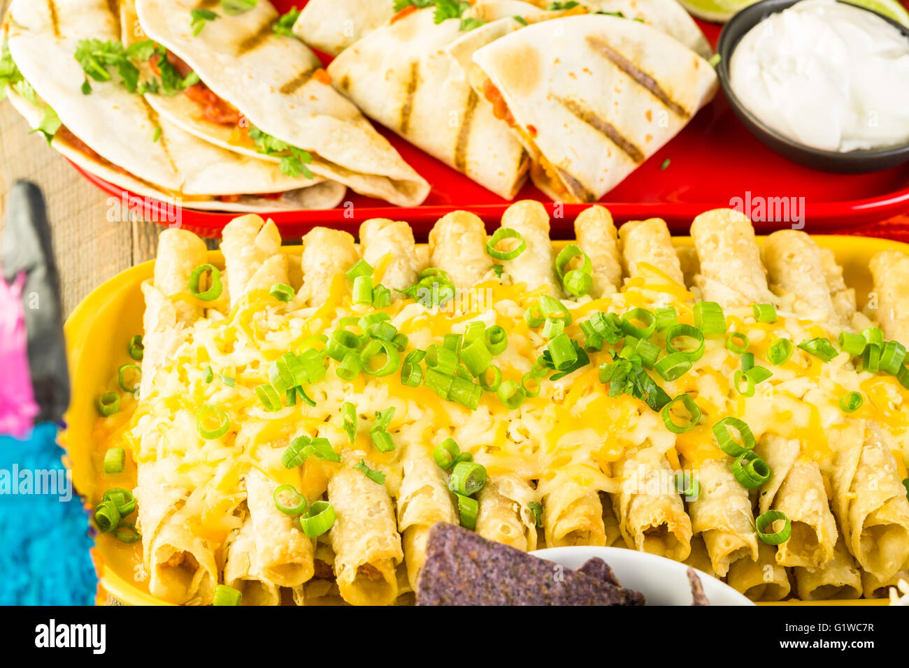 Fiesta party buffet table with chicken taquitos and other traditional ...