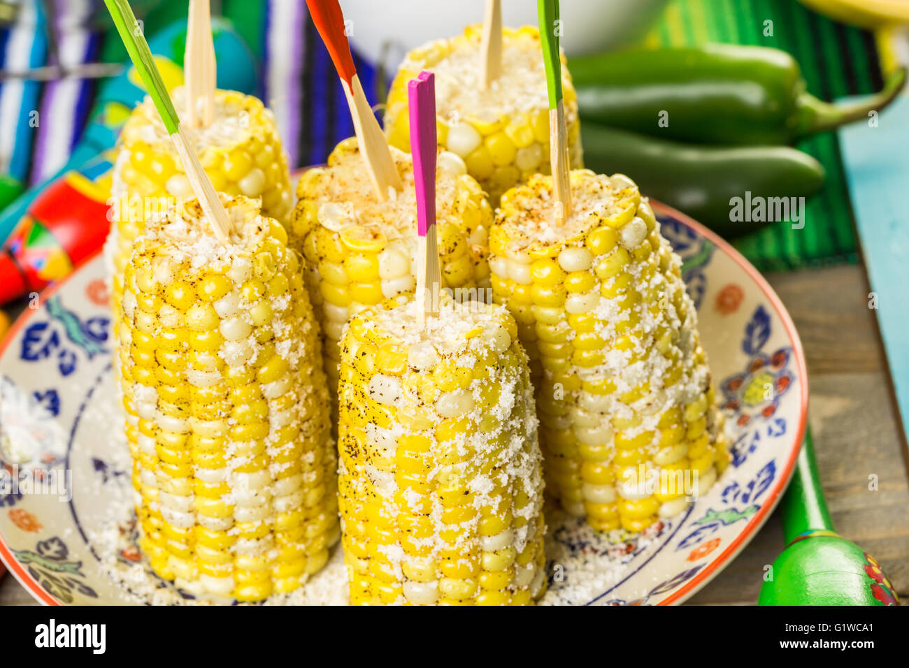Fiesta party buffet table with spicy mexican corn on the cob and other ...