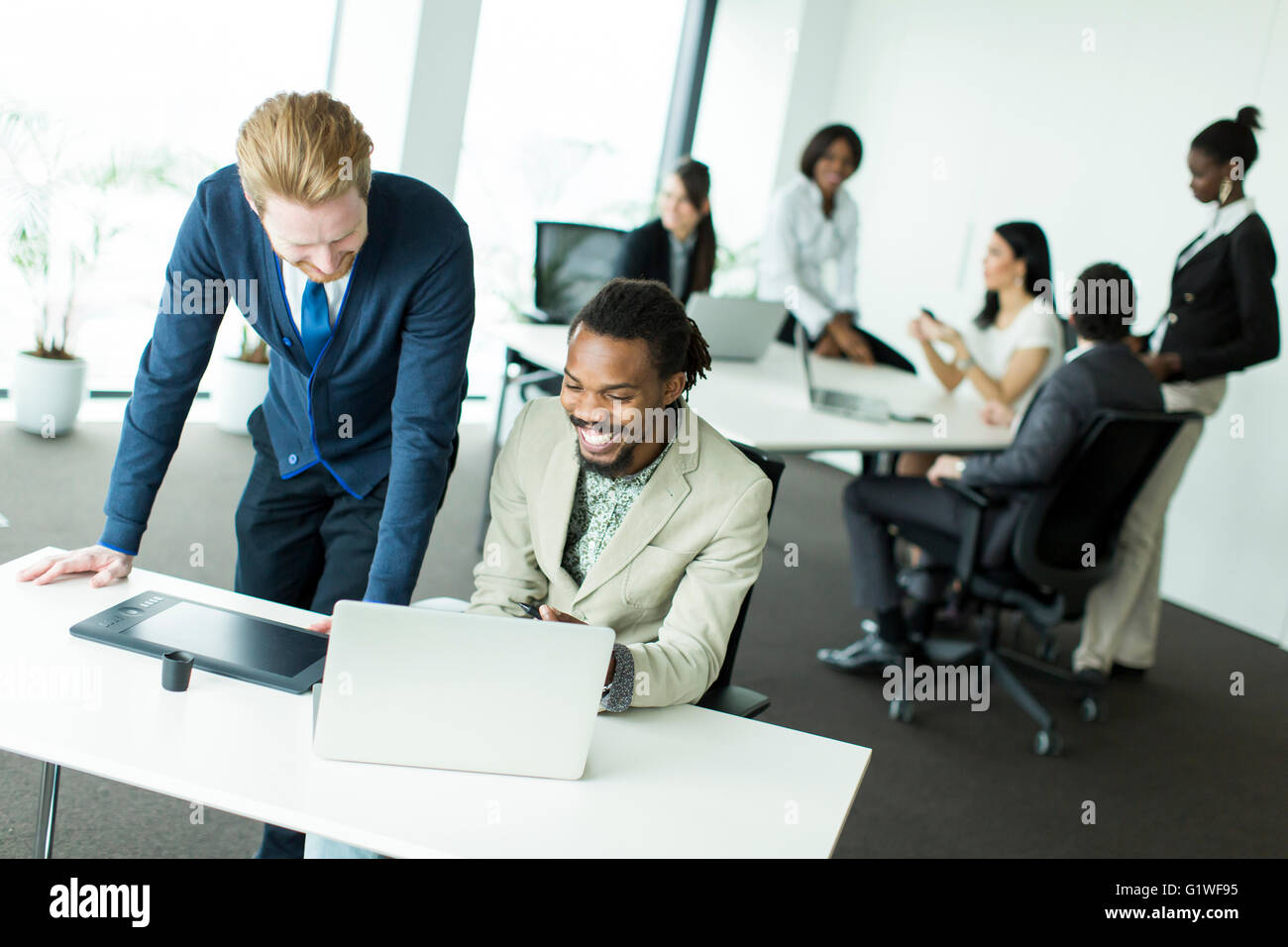 Businessmen working together at the desk in the office Stock Photo - Alamy