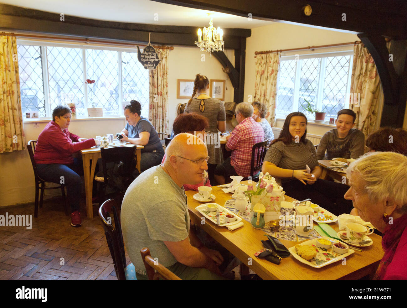 people having afternoon tea in the interior of the Thomas Oken tea ...