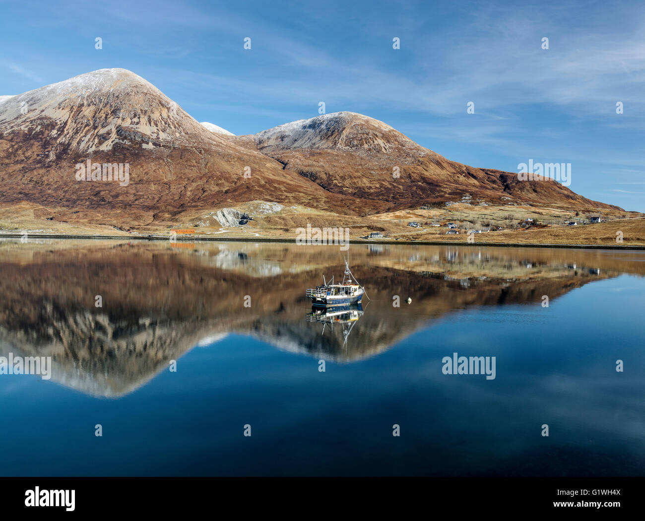 winter mountains at torrin with reflections and mooring boat on loch ...