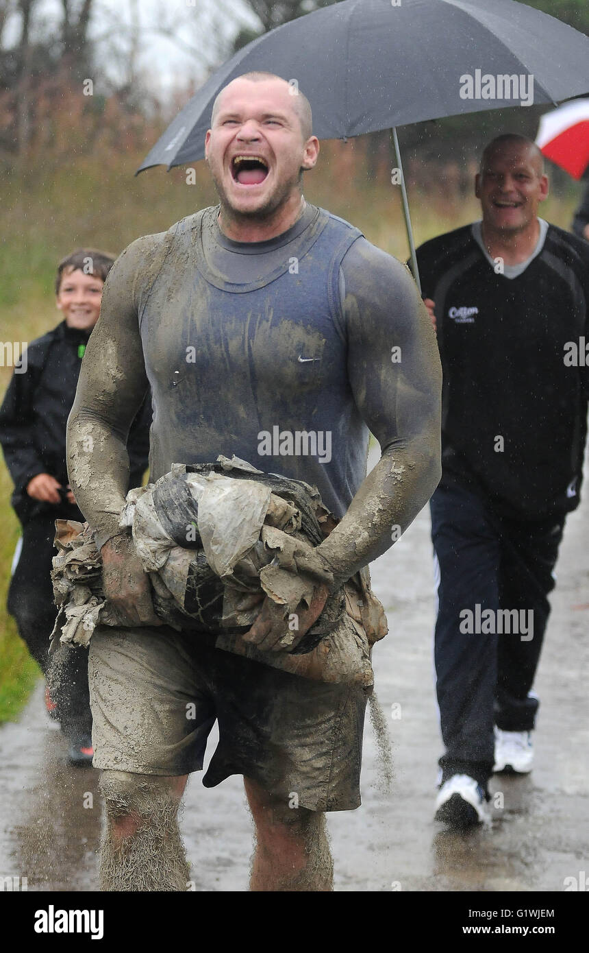 Participants in a cement race where contenders carry heavy packs of ...