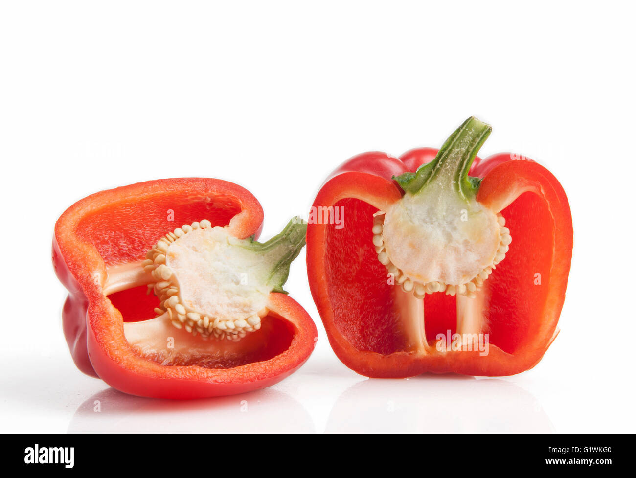 two half red bell pepper isolated on white background Stock Photo - Alamy