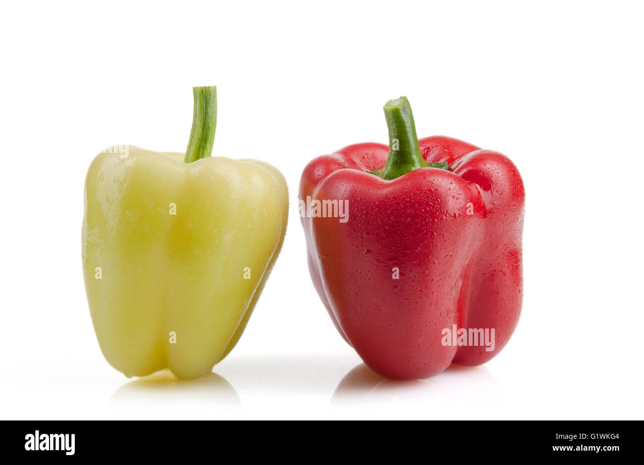 two bell pepper, one red and onegreen, isolated on white background ...