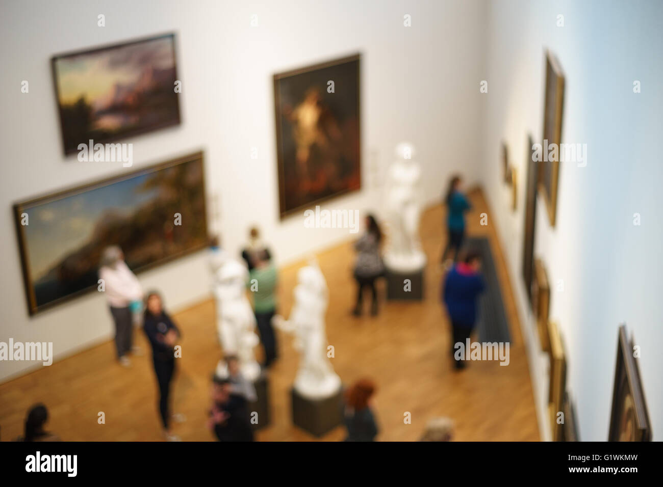 People visiting art gallery or museum and watching paintings and ...