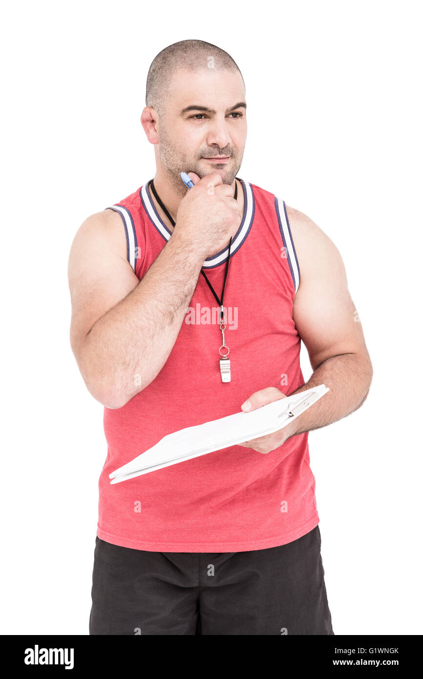 Athlete thinking while writing on clipboard Stock Photo - Alamy