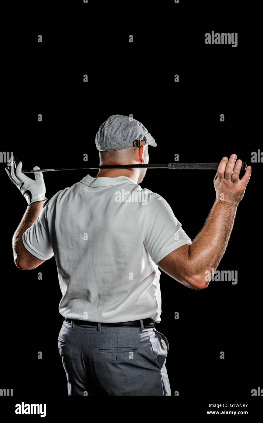Rear view of golf player holding a golf club Stock Photo - Alamy