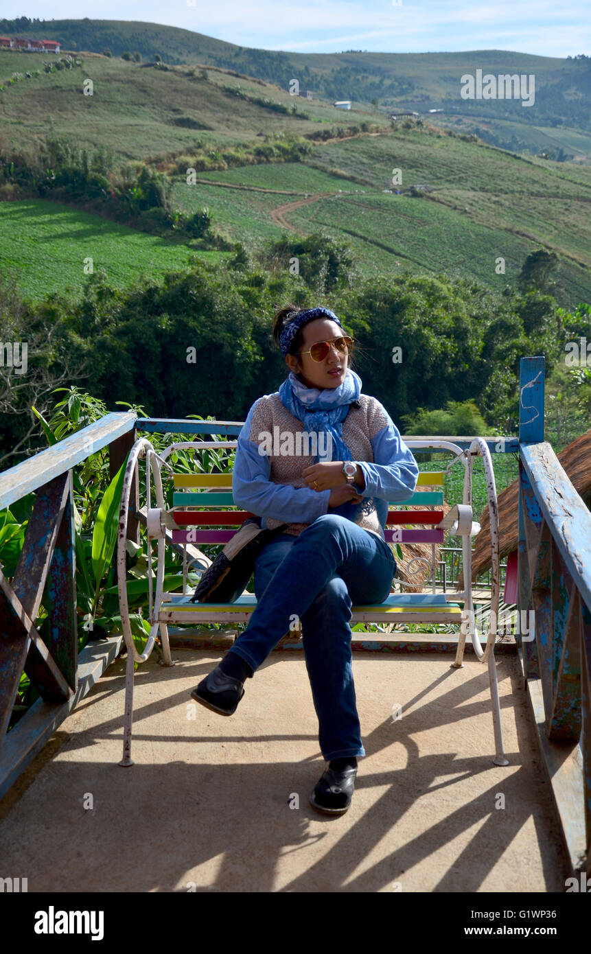 Thai women portrait and sitting on bench swings at Phu Hin Rong Kla ...