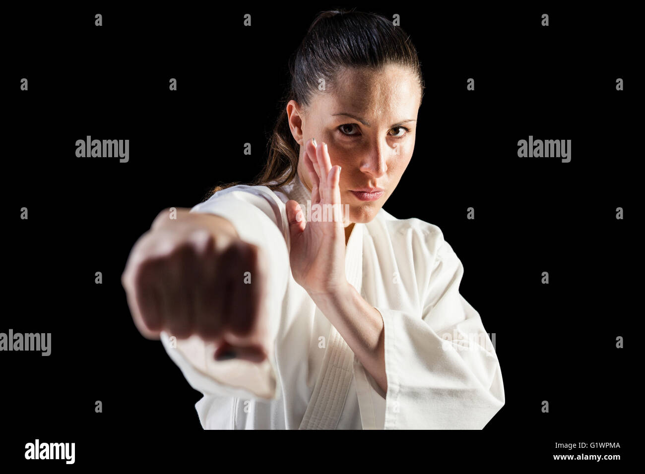 Female fighter performing karate stance Stock Photo - Alamy