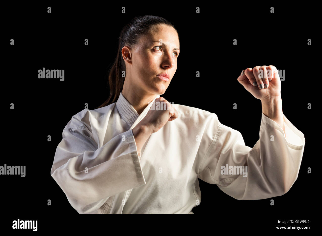 Female fighter performing karate stance Stock Photo - Alamy