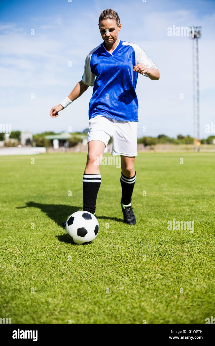 Female football player practicing soccer Stock Photo - Alamy