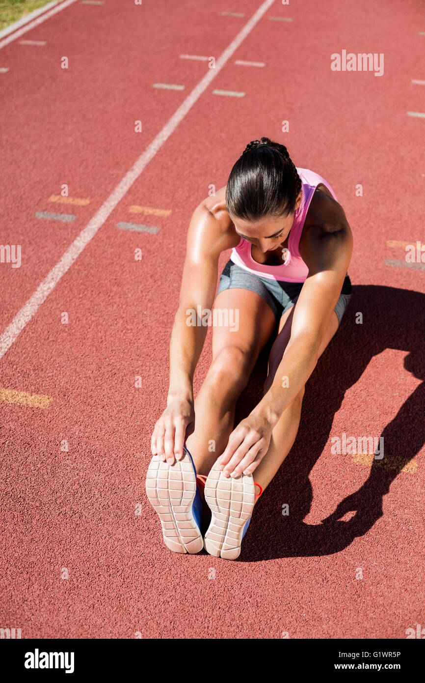 Female athlete stretching her hamstring Stock Photo - Alamy