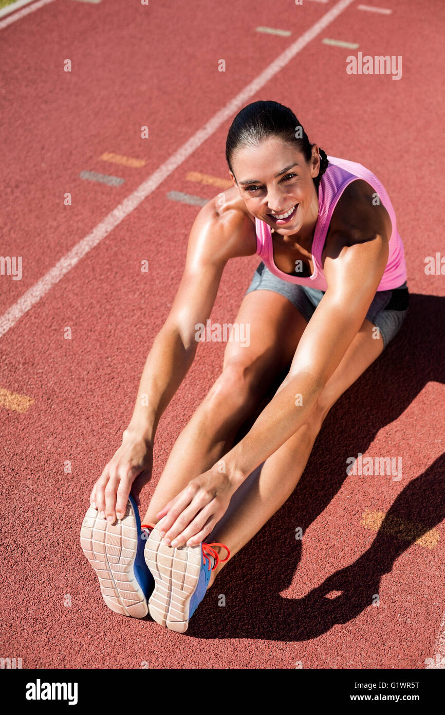 Portrait of female athlete stretching her hamstring Stock Photo - Alamy