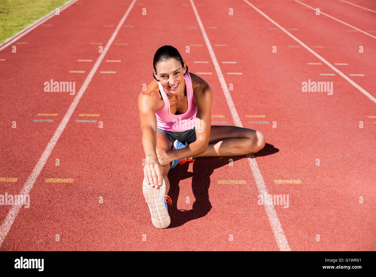 Portrait of female athlete stretching her hamstring Stock Photo - Alamy