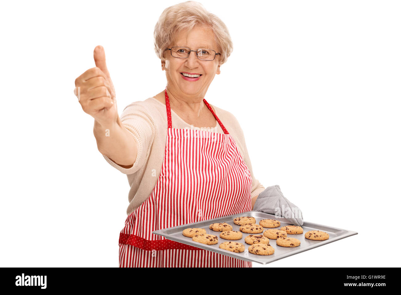 Mature lady holding a tray with chocolate chip cookies and giving a ...