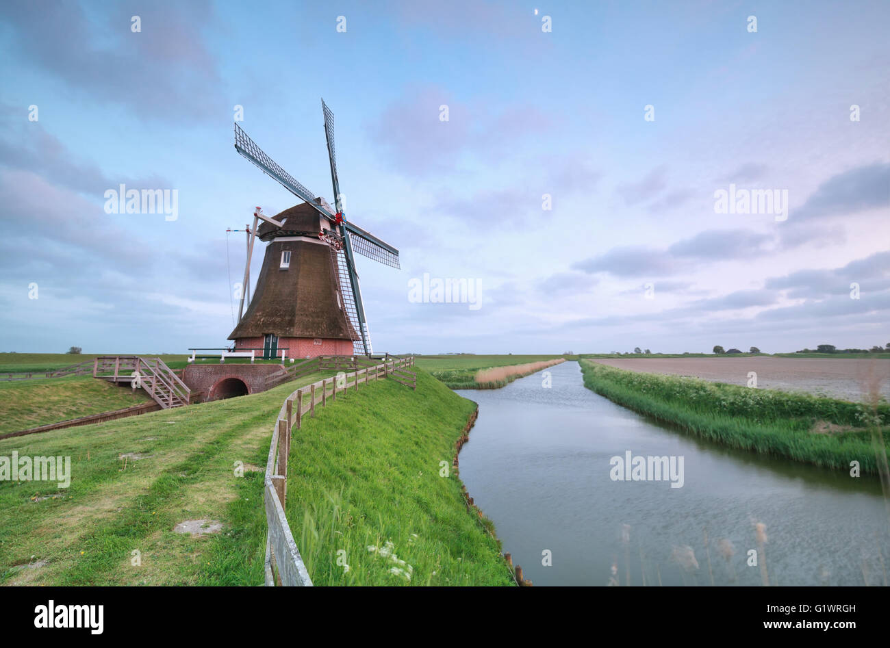 old Dutch windmill by canal, Groningen, Netherlands Stock Photo - Alamy