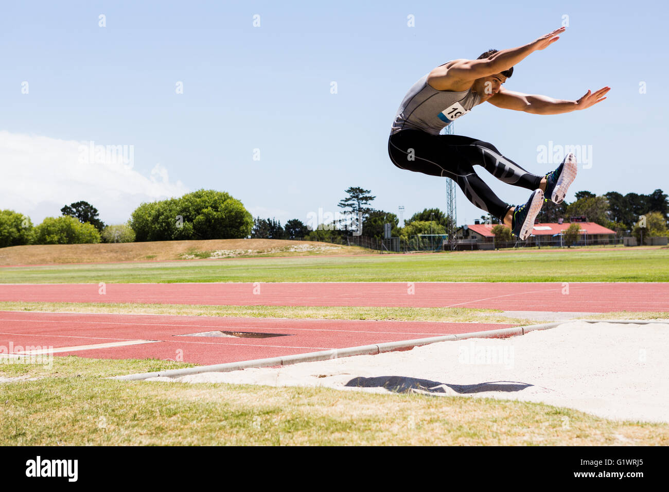 Athlete performing a long jump Stock Photo - Alamy