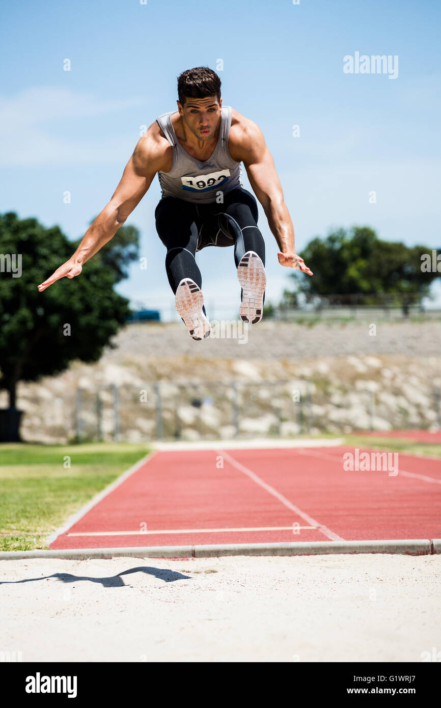 Athlete performing a long jump Stock Photo - Alamy