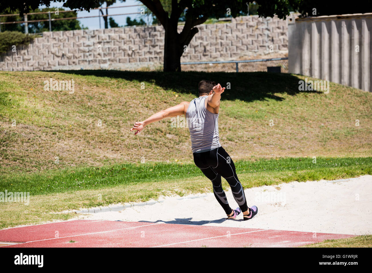 Athlete performing a long jump Stock Photo - Alamy