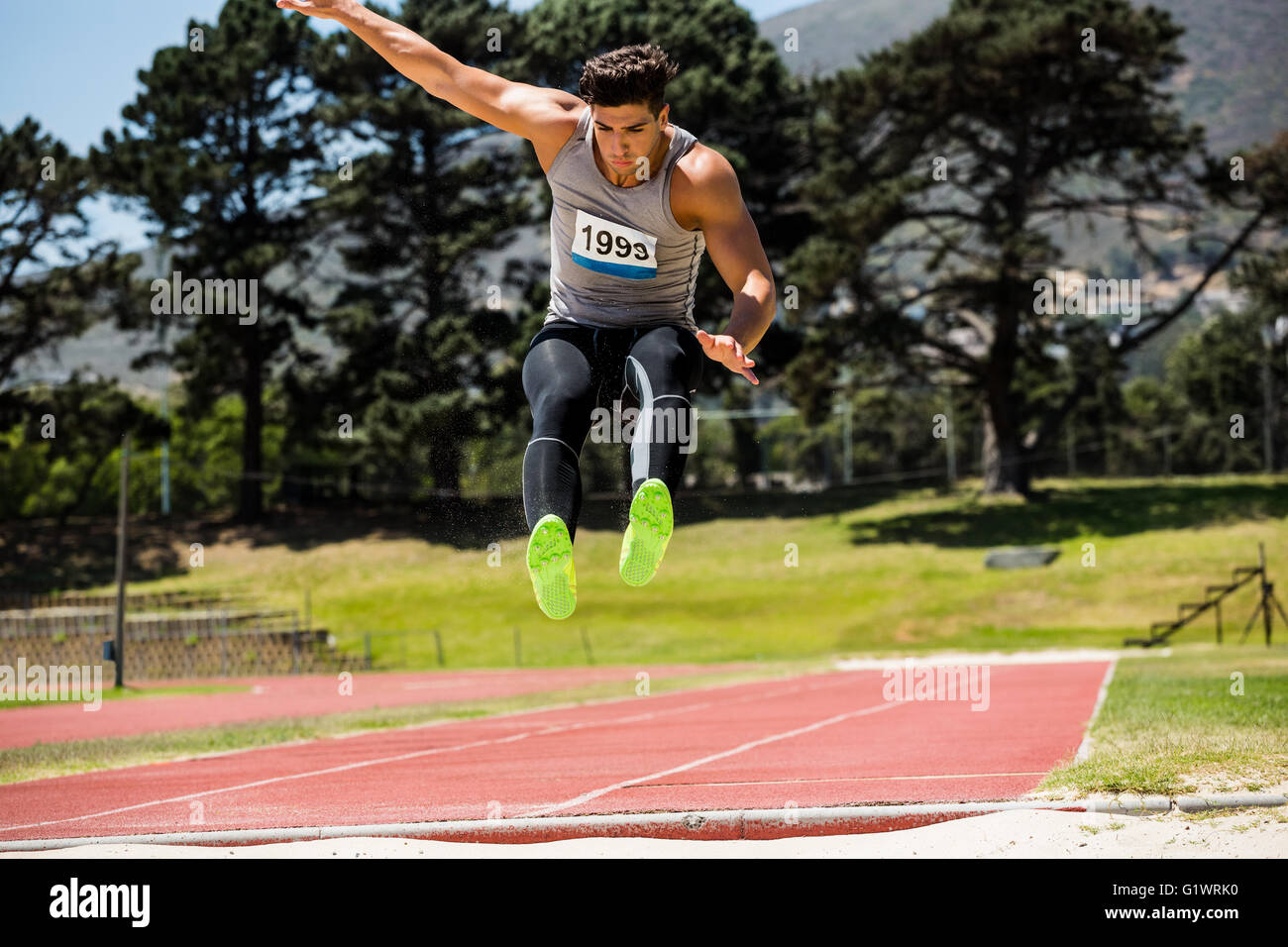 Athlete performing a long jump Stock Photo - Alamy