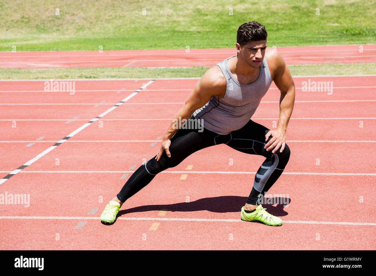 Athlete warming up on the running track Stock Photo - Alamy