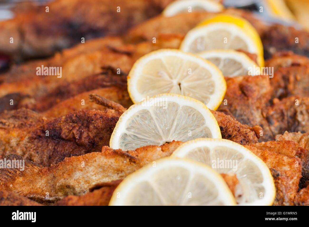 Fresh fried fish with lemon slice. Close-up shot Stock Photo - Alamy