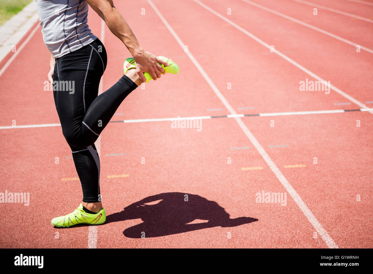 Athlete warming up on the running track Stock Photo - Alamy