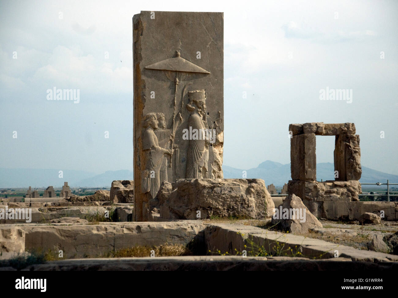 In Iran's grand ruins of a palace complex, Persepolis, a tall carved ...