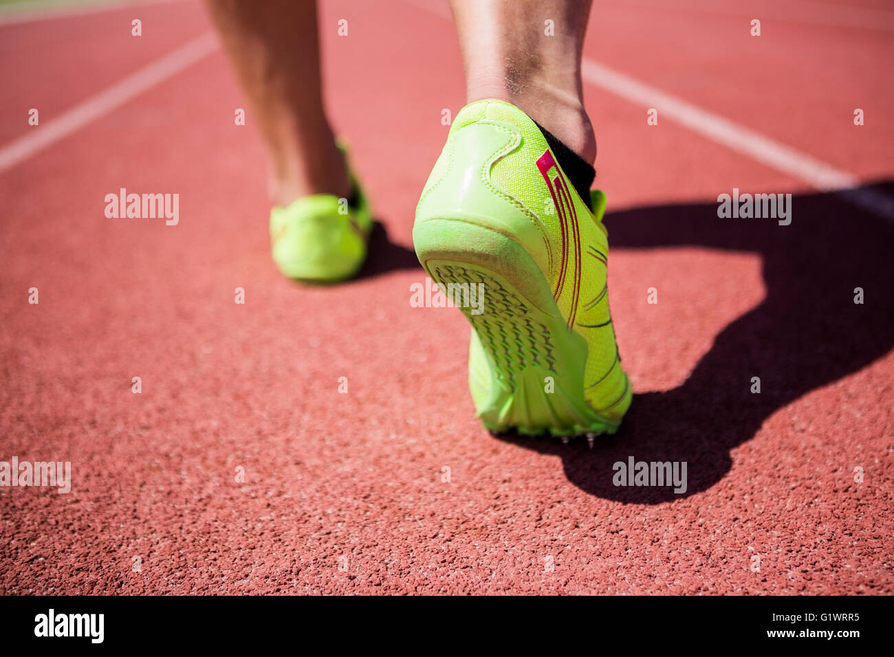 Athletes feet running on the racing track Stock Photo - Alamy