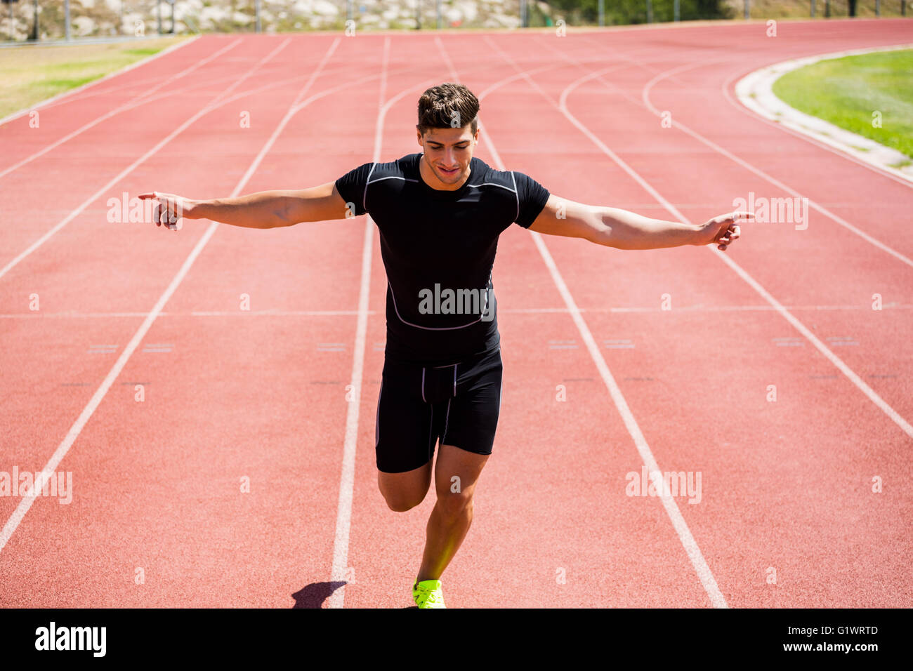 Athlete running on running track Stock Photo - Alamy