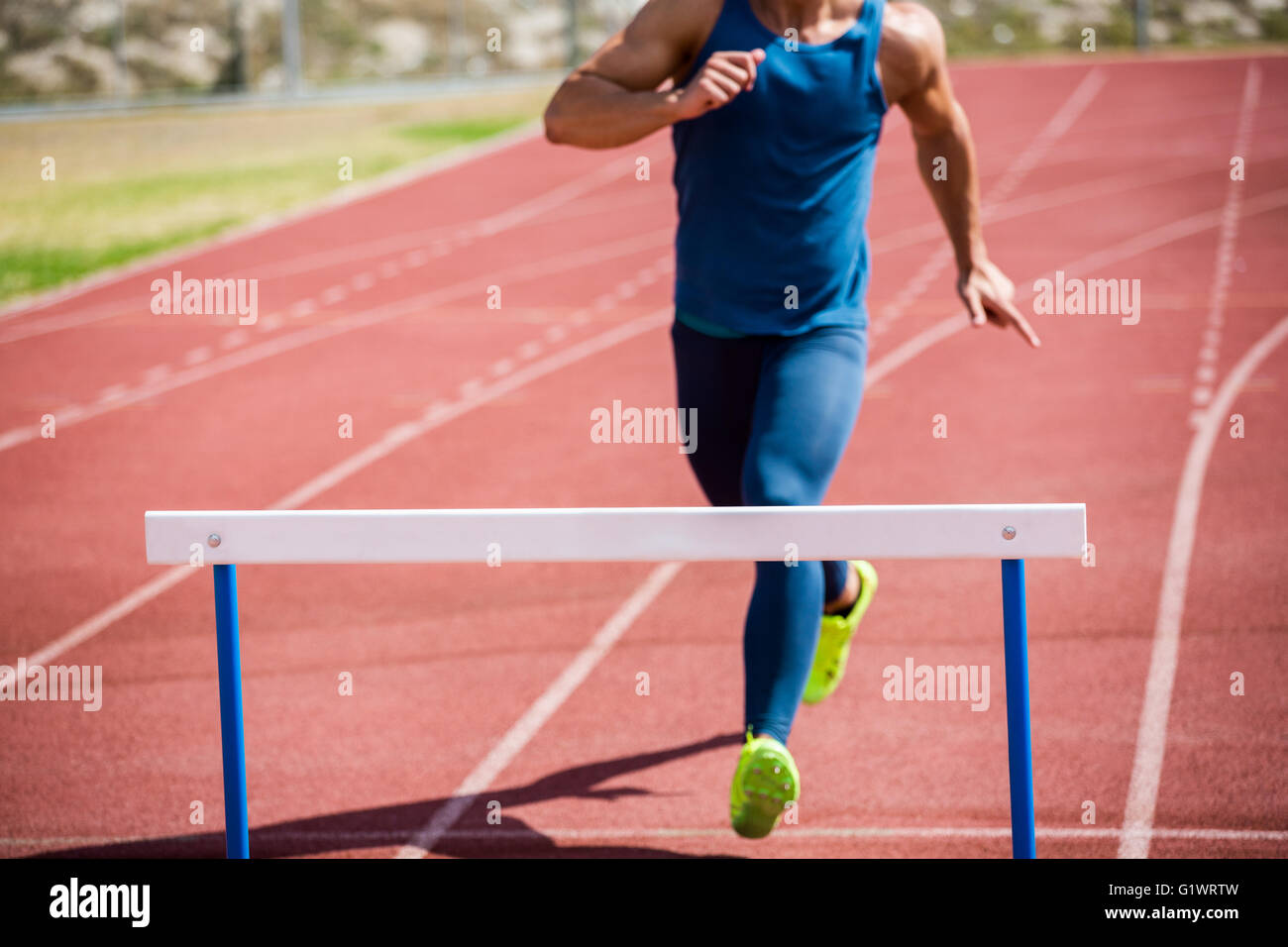 Athlete ready to jump a hurdle Stock Photo - Alamy