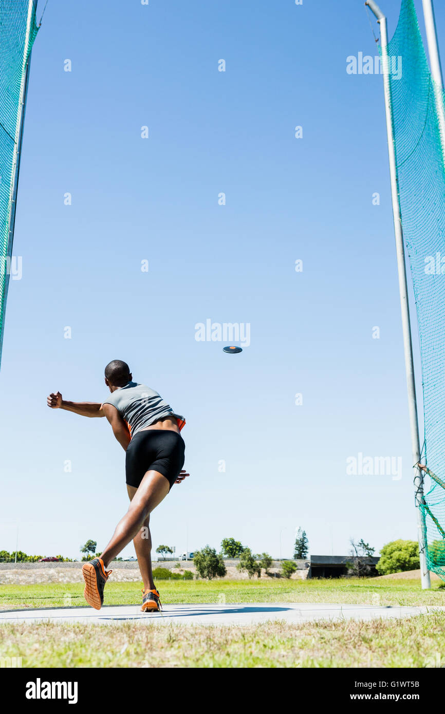 Athlete throwing discus in stadium Stock Photo - Alamy