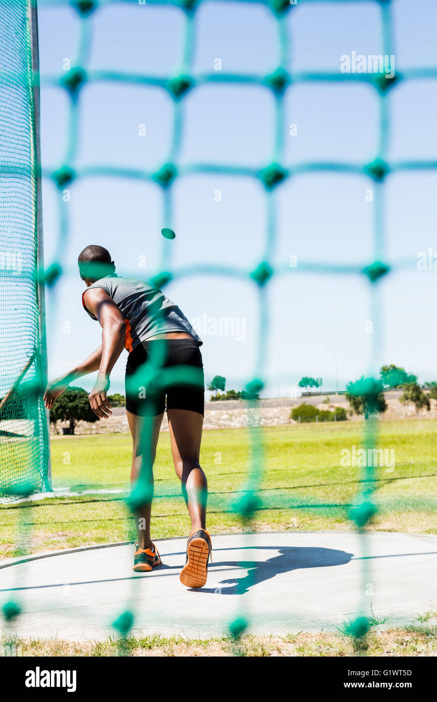 Athlete throwing discus in stadium Stock Photo - Alamy