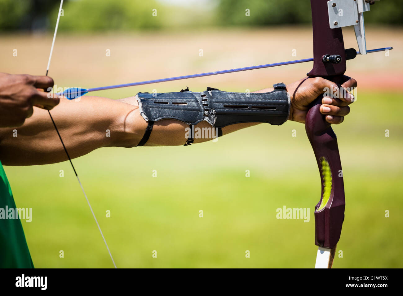 Athletes hand practicing archery Stock Photo - Alamy