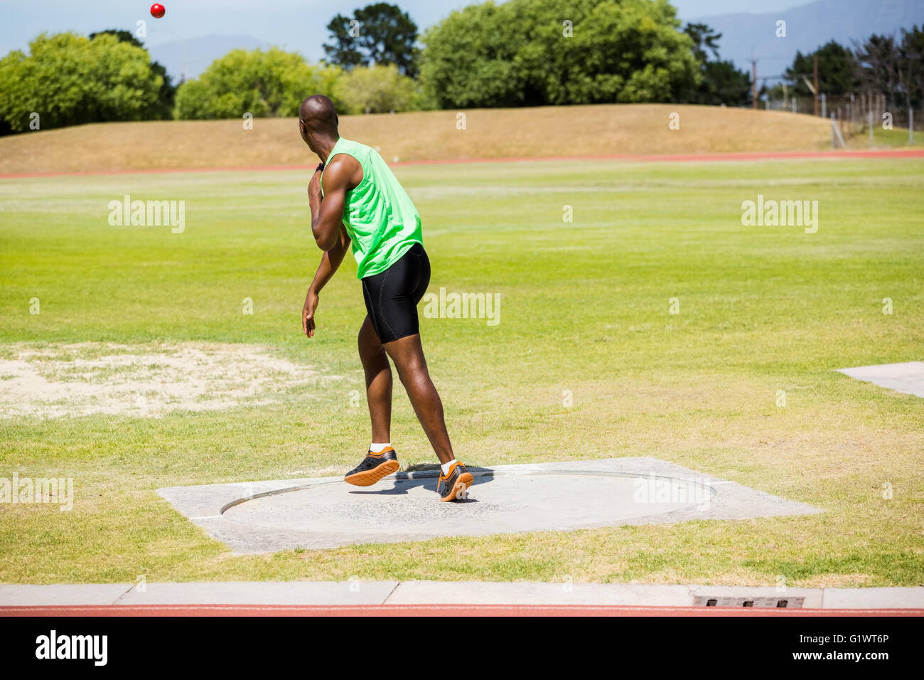 Male athlete throwing shot put ball Stock Photo - Alamy