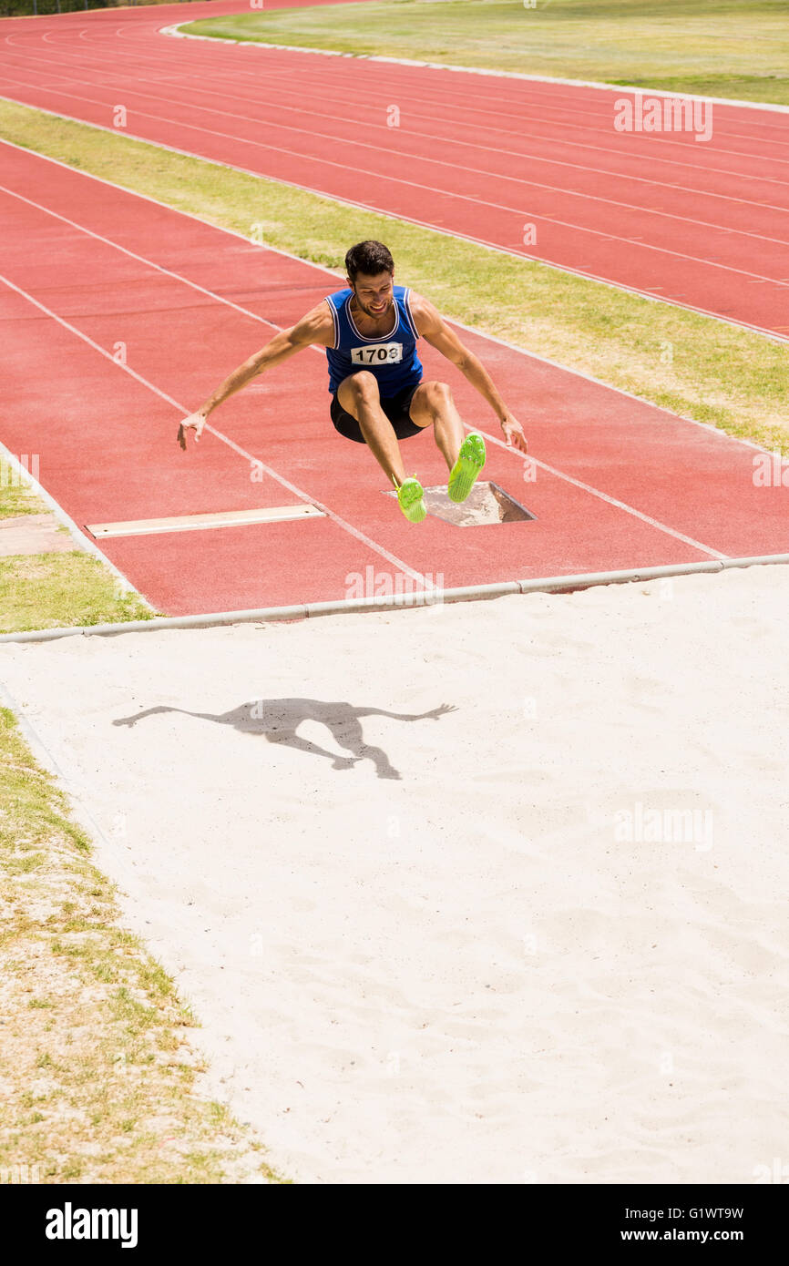 Athlete performing a long jump Stock Photo - Alamy
