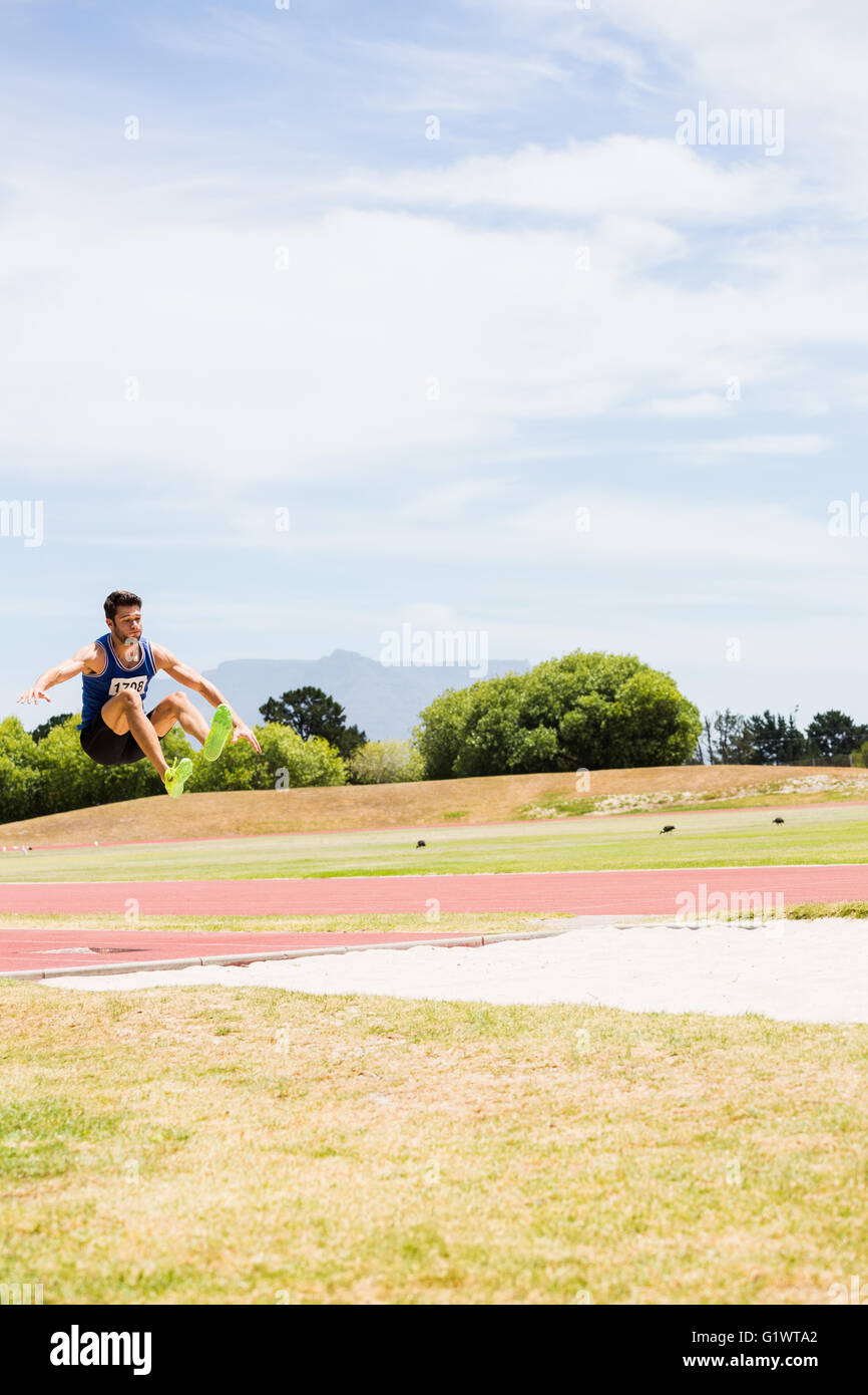 Athlete performing a long jump Stock Photo - Alamy