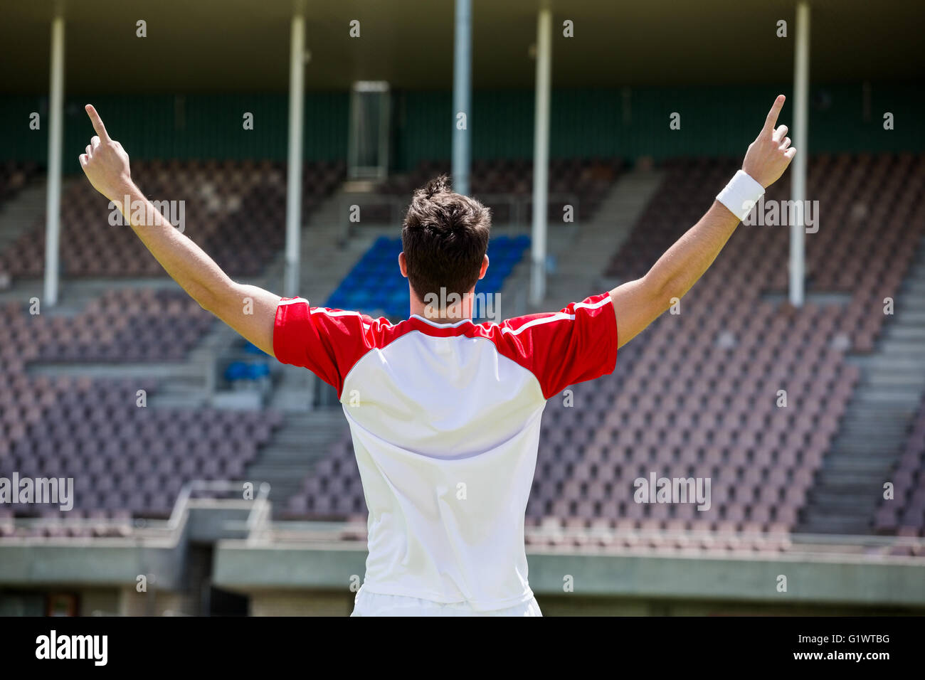 Excited football player standing in stadium Stock Photo - Alamy
