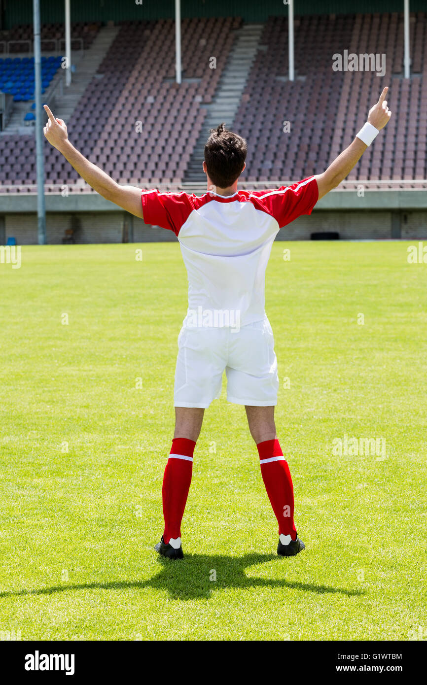 Excited football player standing in stadium Stock Photo - Alamy