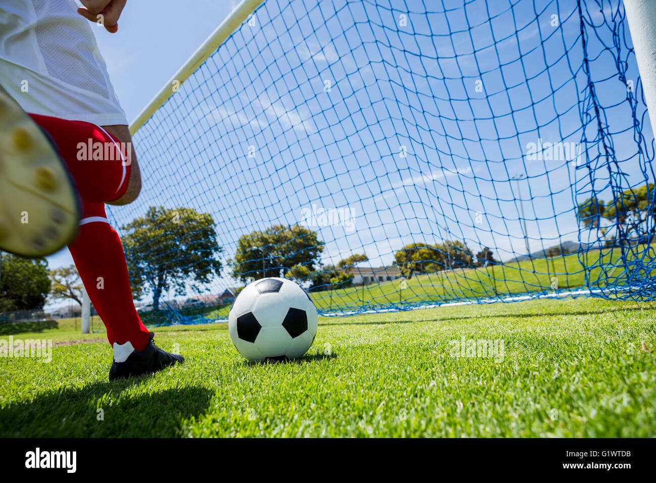 Football player scoring a goal Stock Photo - Alamy
