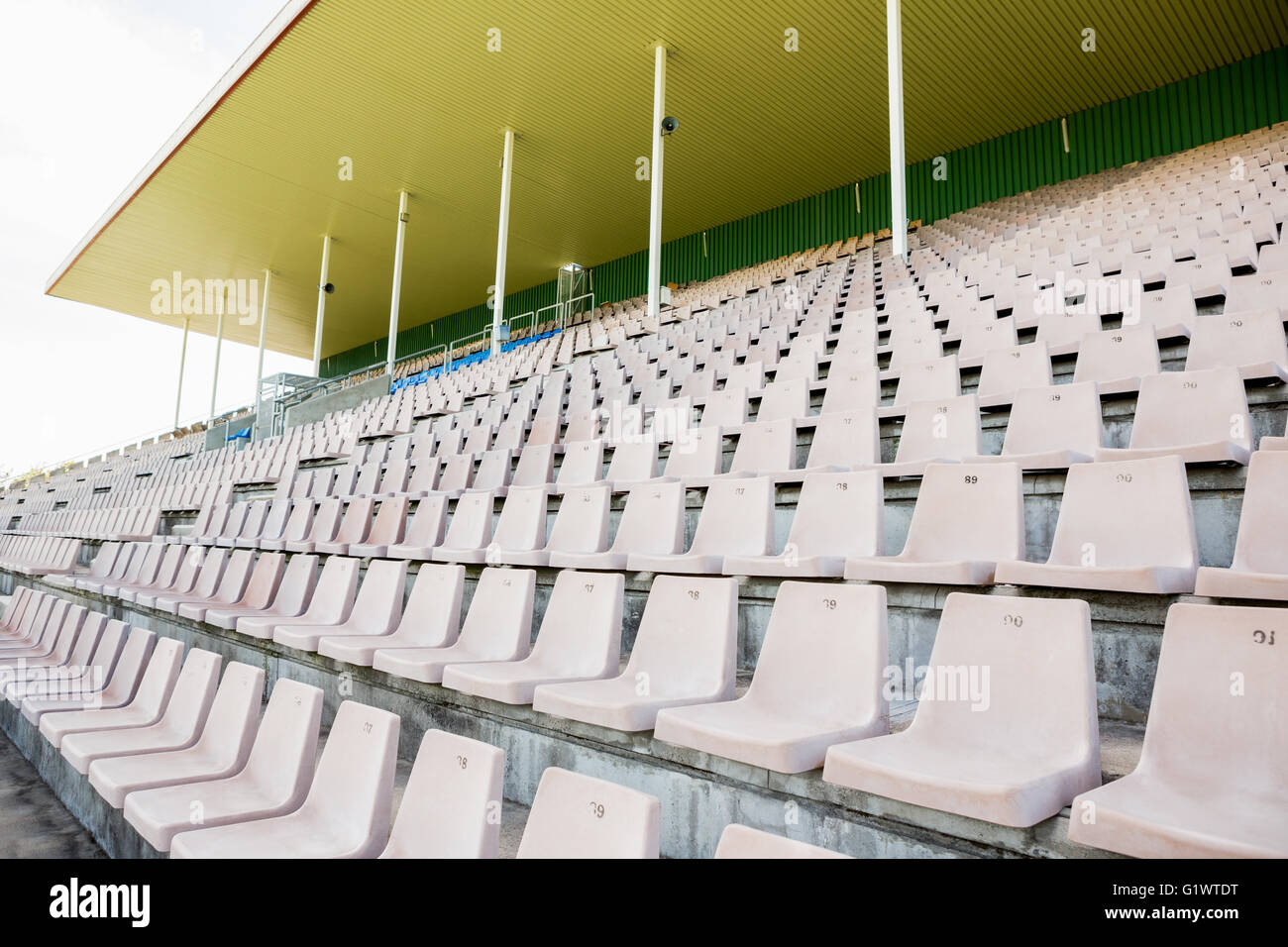 Empty row of white seats Stock Photo - Alamy
