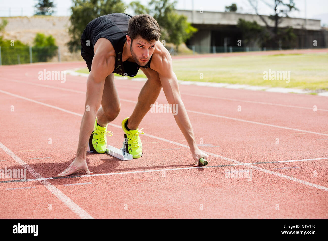 Athlete ready to start the relay race Stock Photo - Alamy