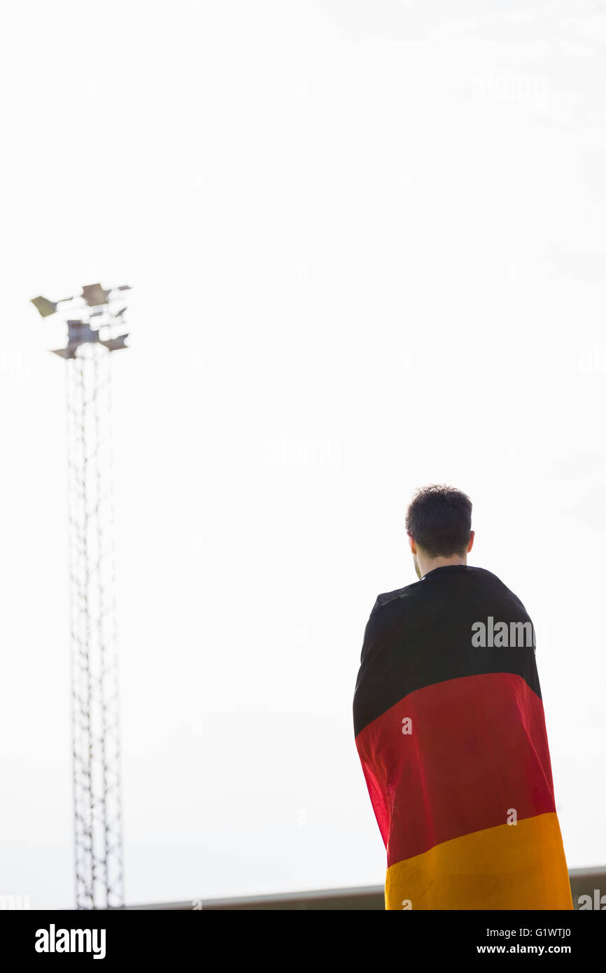 Athlete with german flag wrapped around his body Stock Photo - Alamy