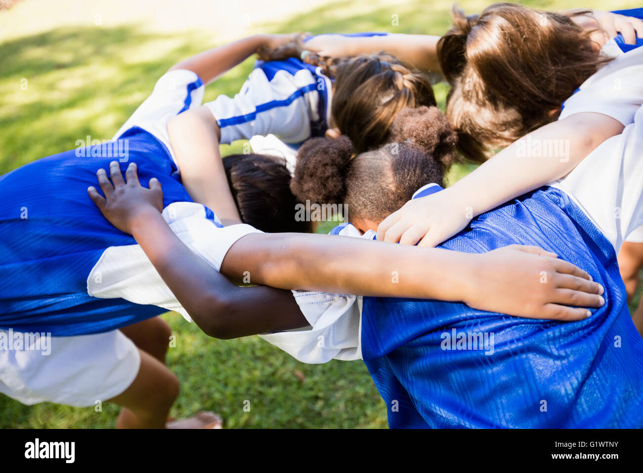Overhead view of soccer team forming huddle Stock Photo - Alamy
