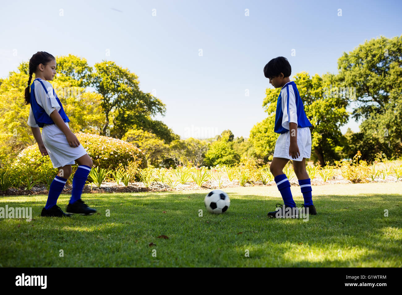 Cute football players playing football Stock Photo - Alamy