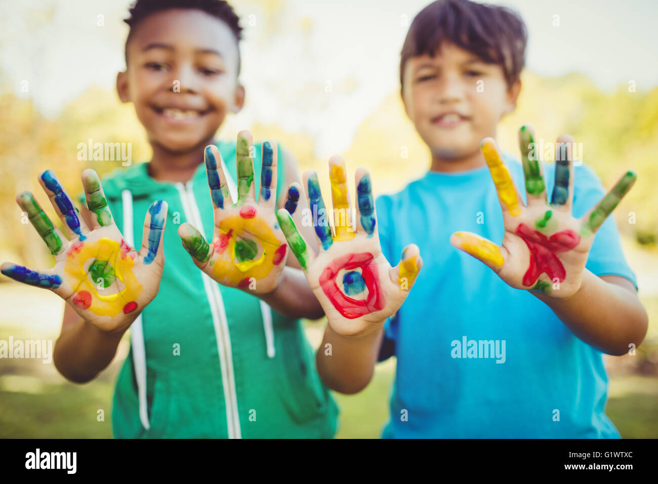 Portrait of two boys showing their hands to the camera Stock Photo - Alamy