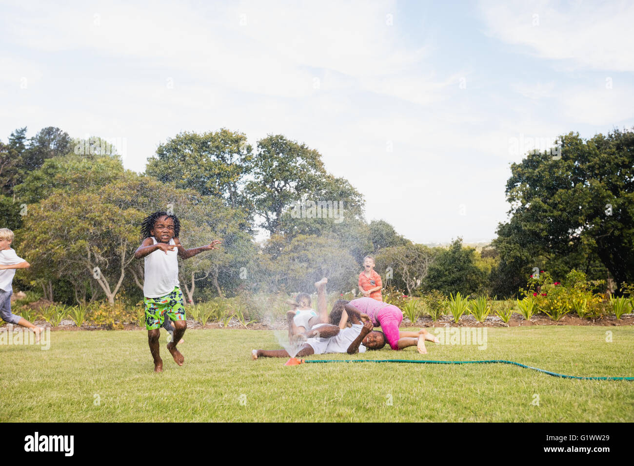 Kids playing together during a sunny day Stock Photo - Alamy